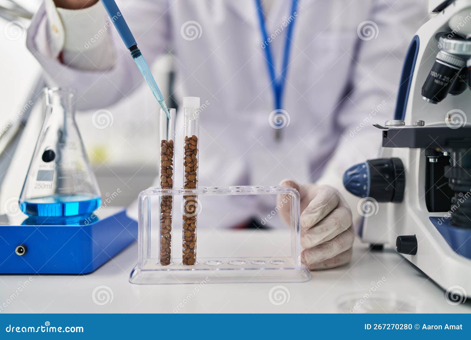 Young Hispanic Man Scientist Using Pipette Pouring Liquid at Laboratory ...