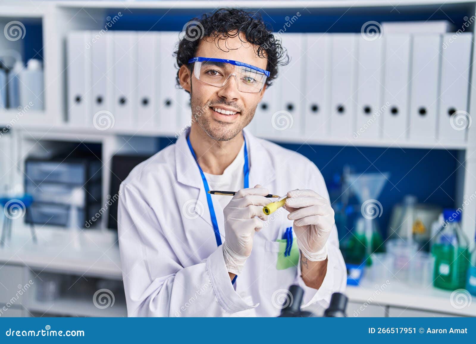 Young Hispanic Man Scientist Writing on Test Tube at Laboratory Stock ...