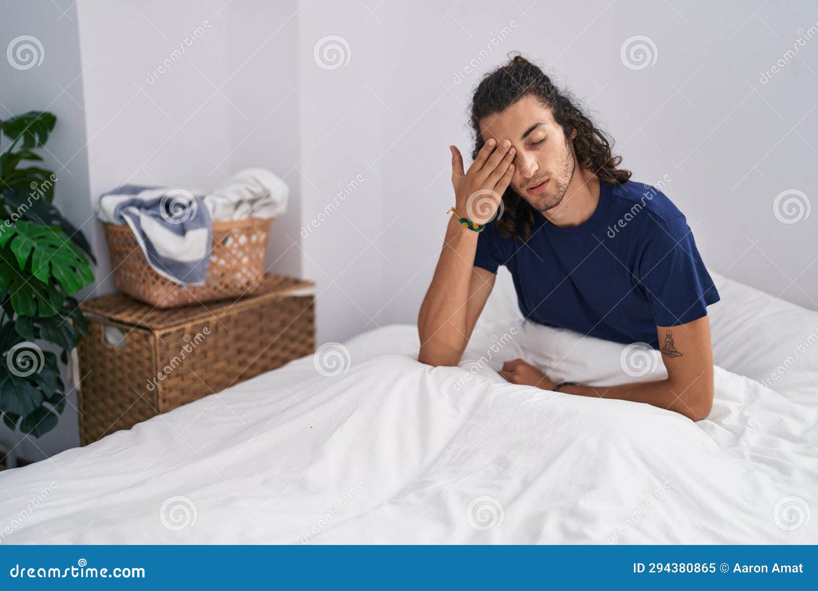 Young Hispanic Man Sitting on Bed Tired at Bedroom Stock Image - Image ...