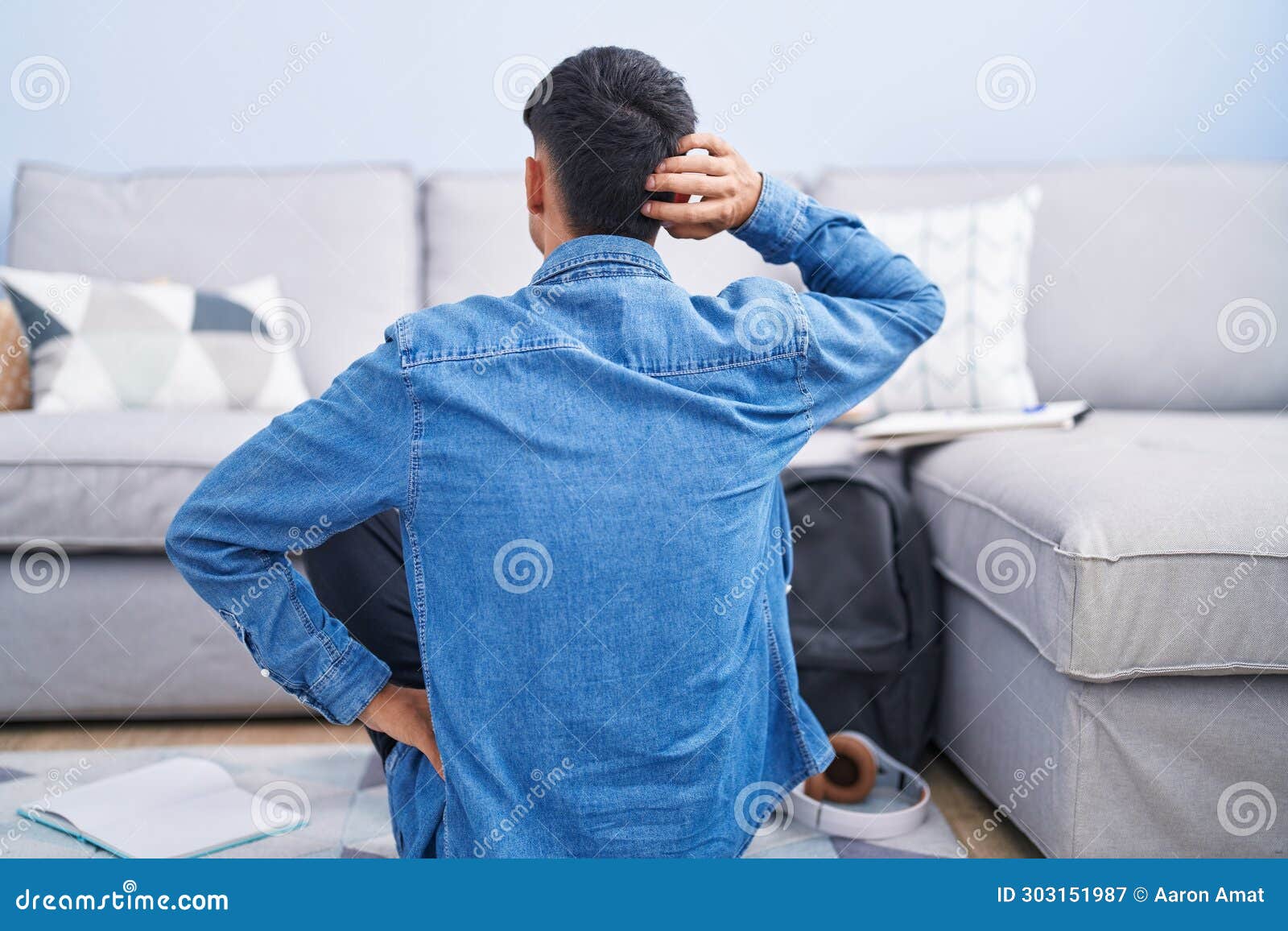Young Hispanic Man Sitting on the Floor Studying for University ...