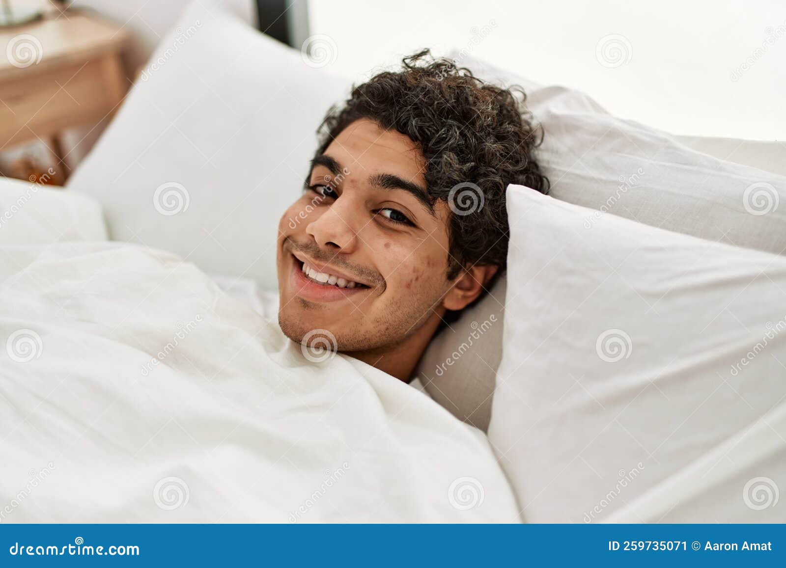 Young Hispanic Man Smiling Happy Lying on the Bed at Bedroom Stock ...