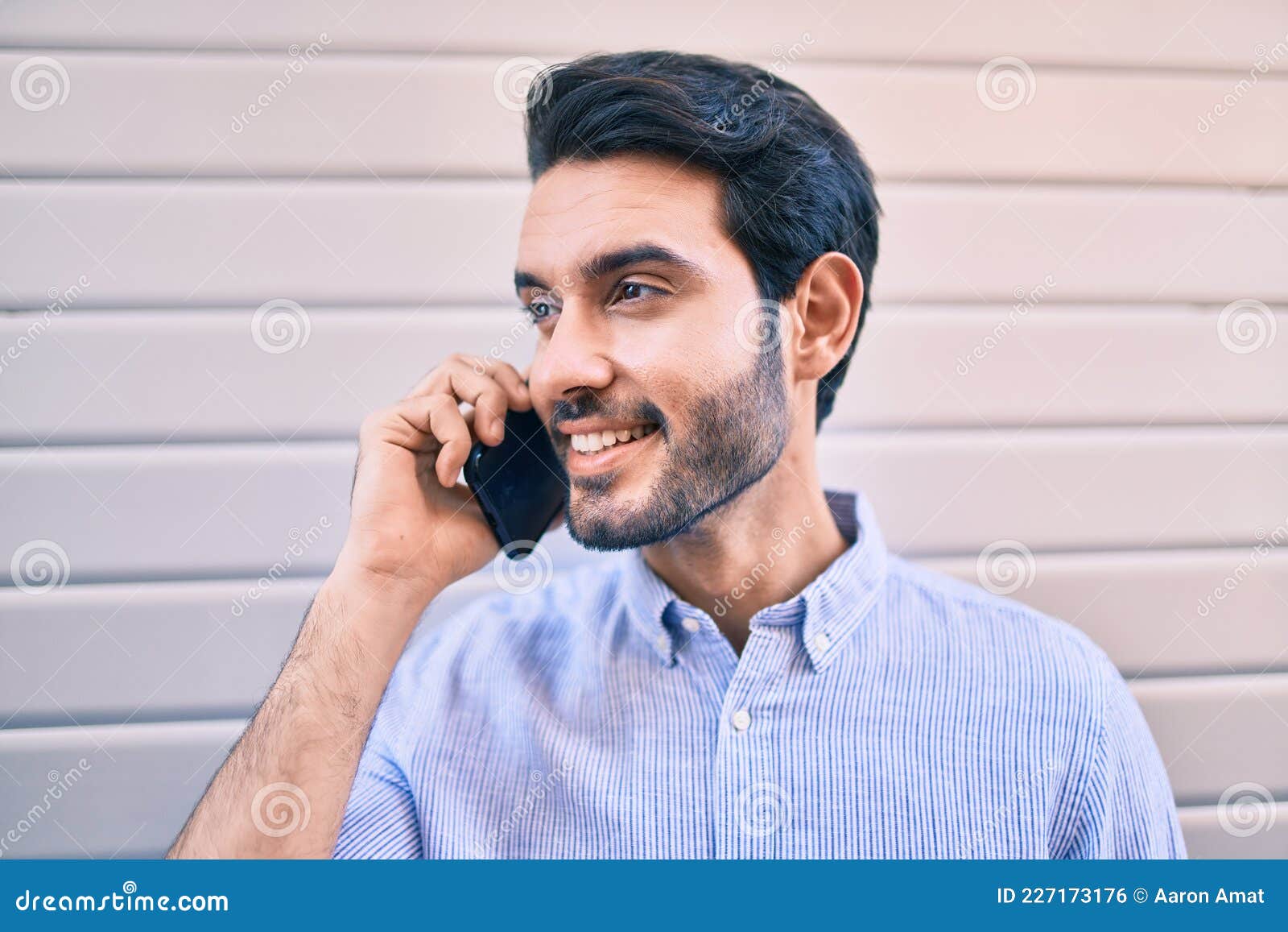 Young Hispanic Man Smiling Happy Talking on the Smartphone Leaning on ...