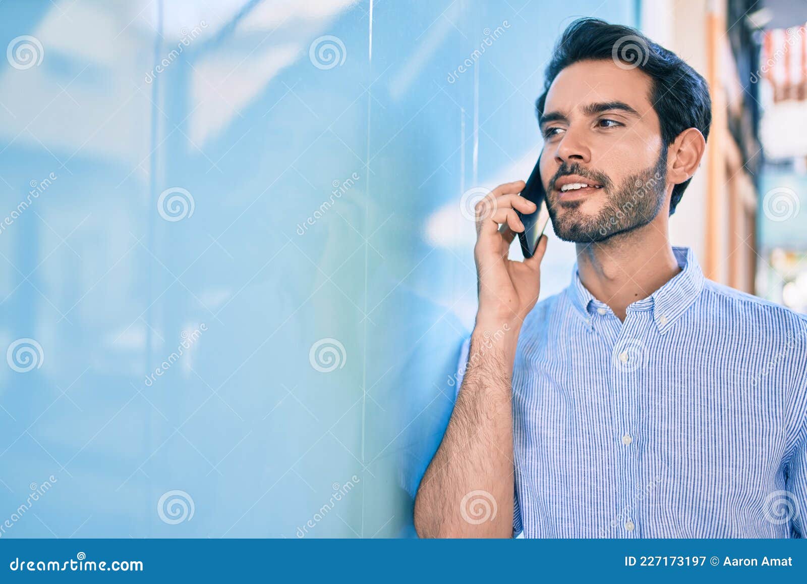 Young Hispanic Man Smiling Happy Talking on the Smartphone Leaning on ...