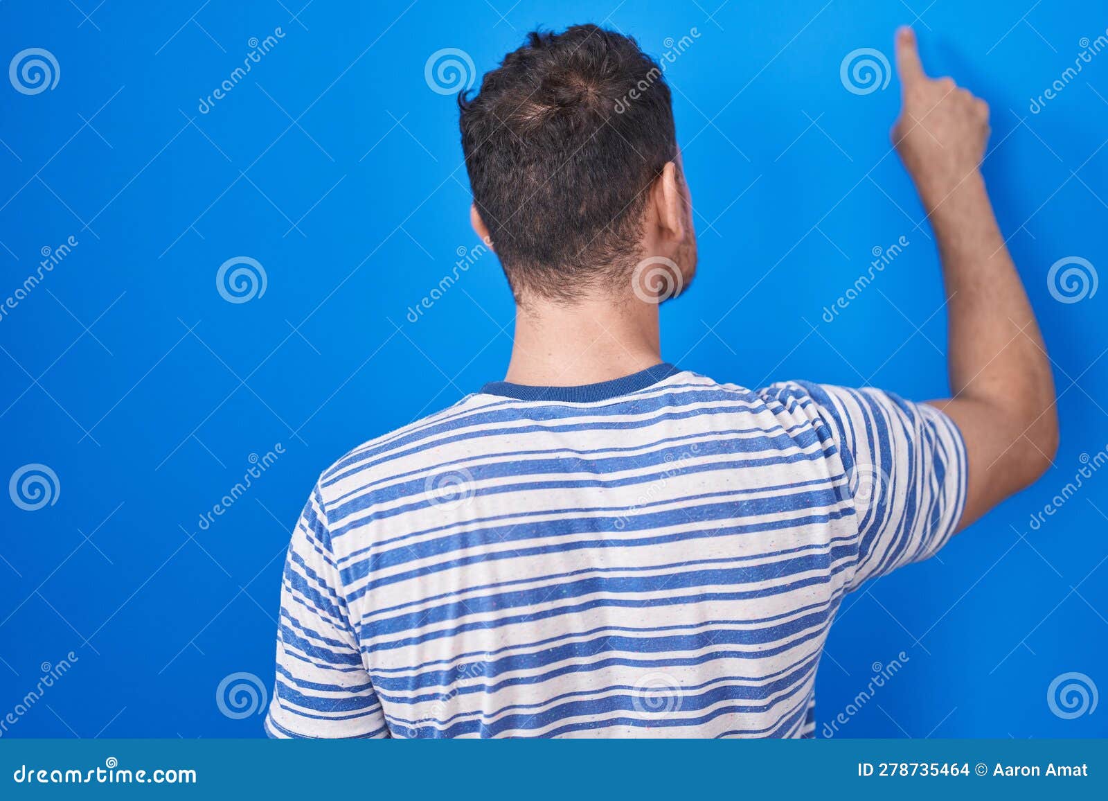 Young Hispanic Man Standing Over Blue Background Posing Backwards ...