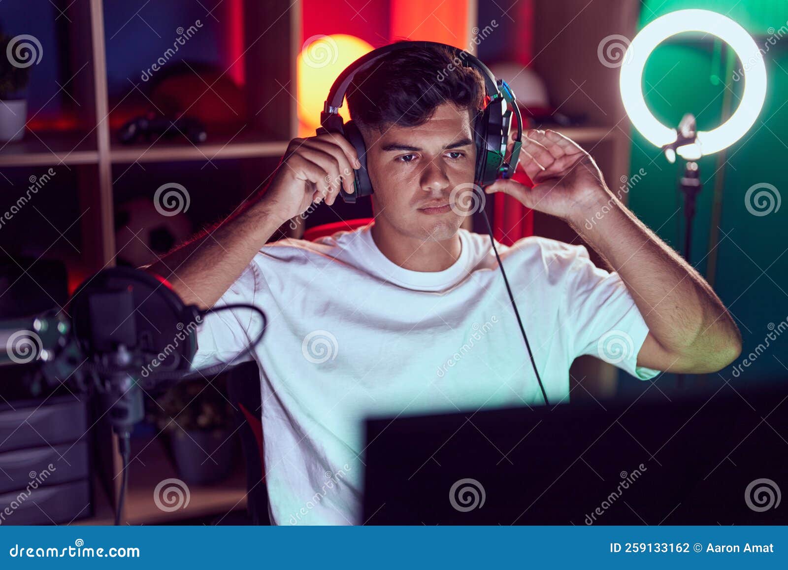 Young Hispanic Man Streamer Playing Video Game Using Computer at Gaming ...