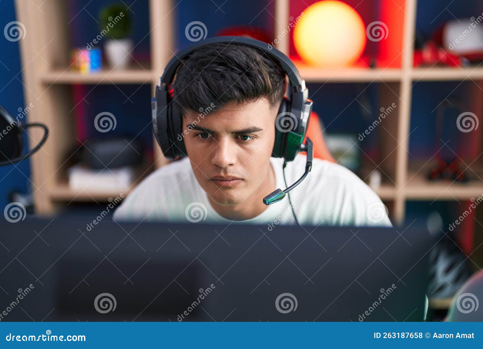 Young Hispanic Man Streamer Playing Video Game Using Computer at Gaming ...
