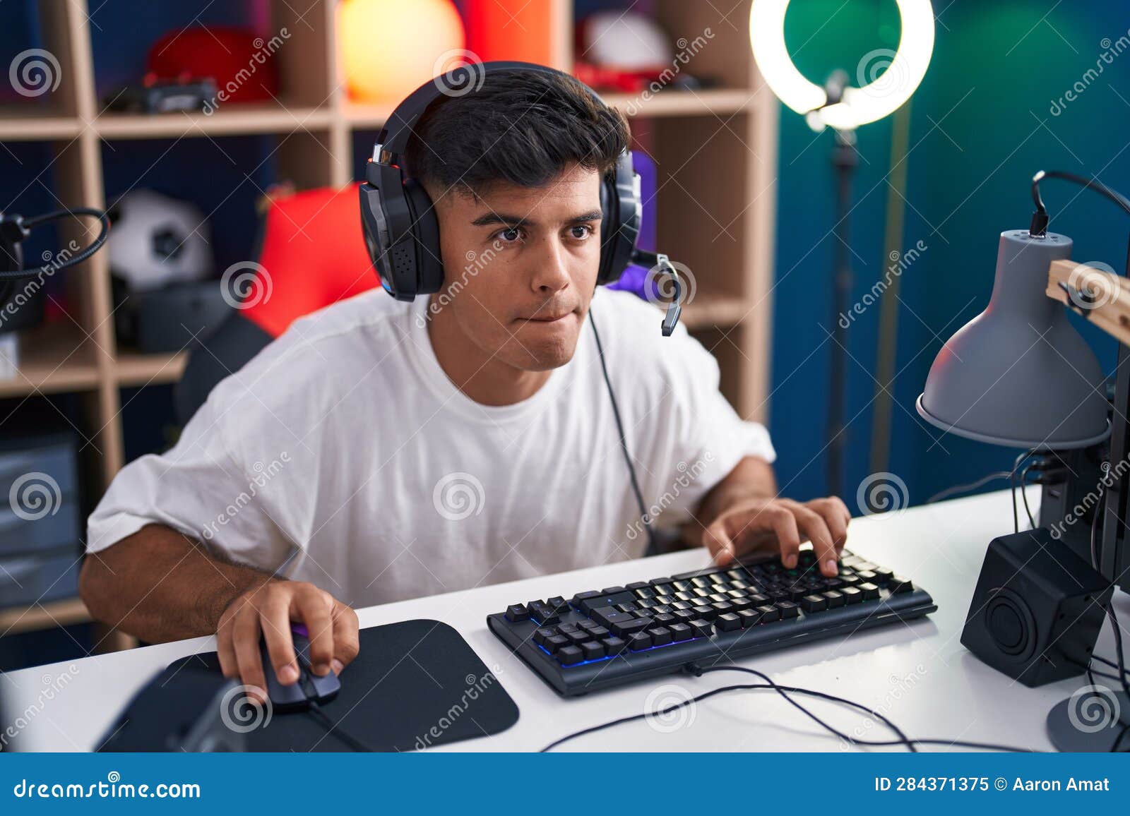 Young Hispanic Man Streamer Playing Video Game Using Computer at Gaming ...