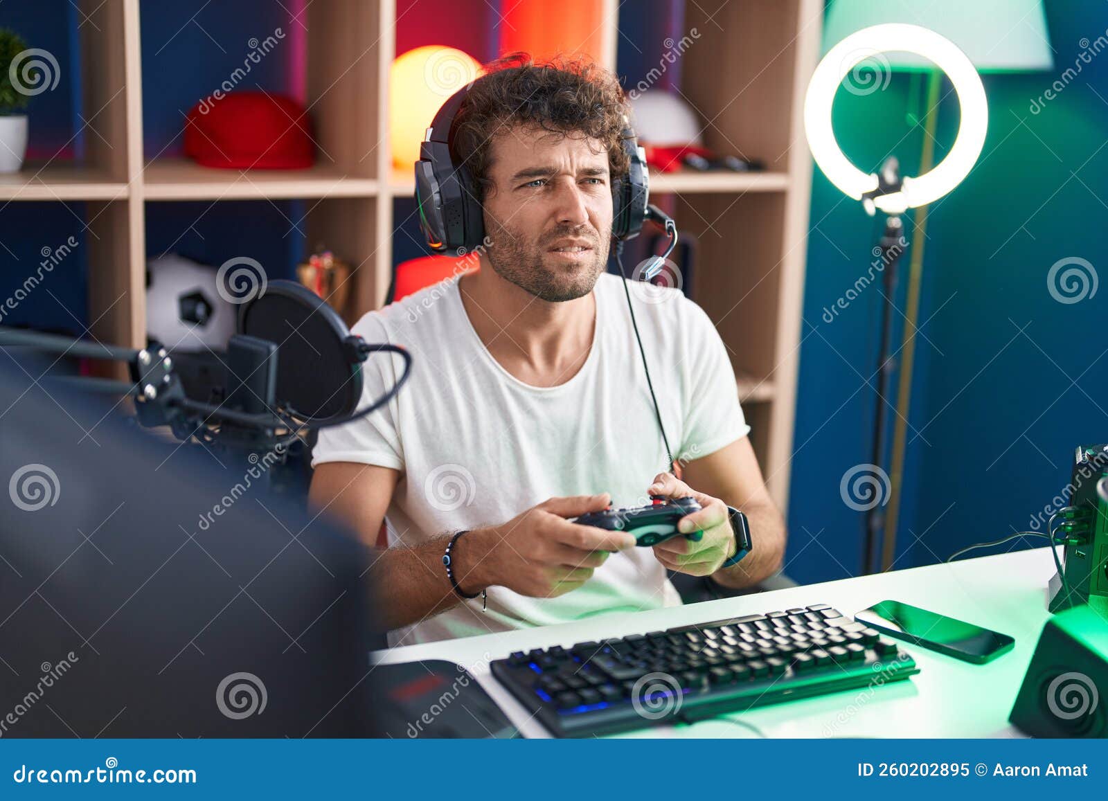 Young Hispanic Man Streamer Playing Video Game Using Joystick at Music ...