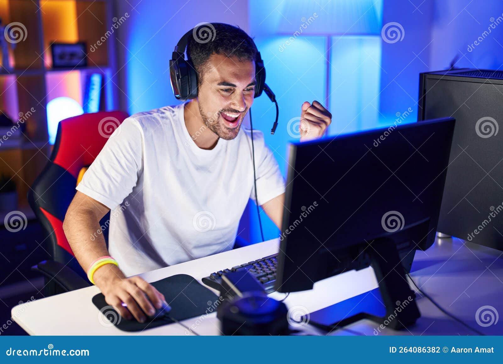 Young Hispanic Man Streamer Playing Video Game with Winner Expression ...