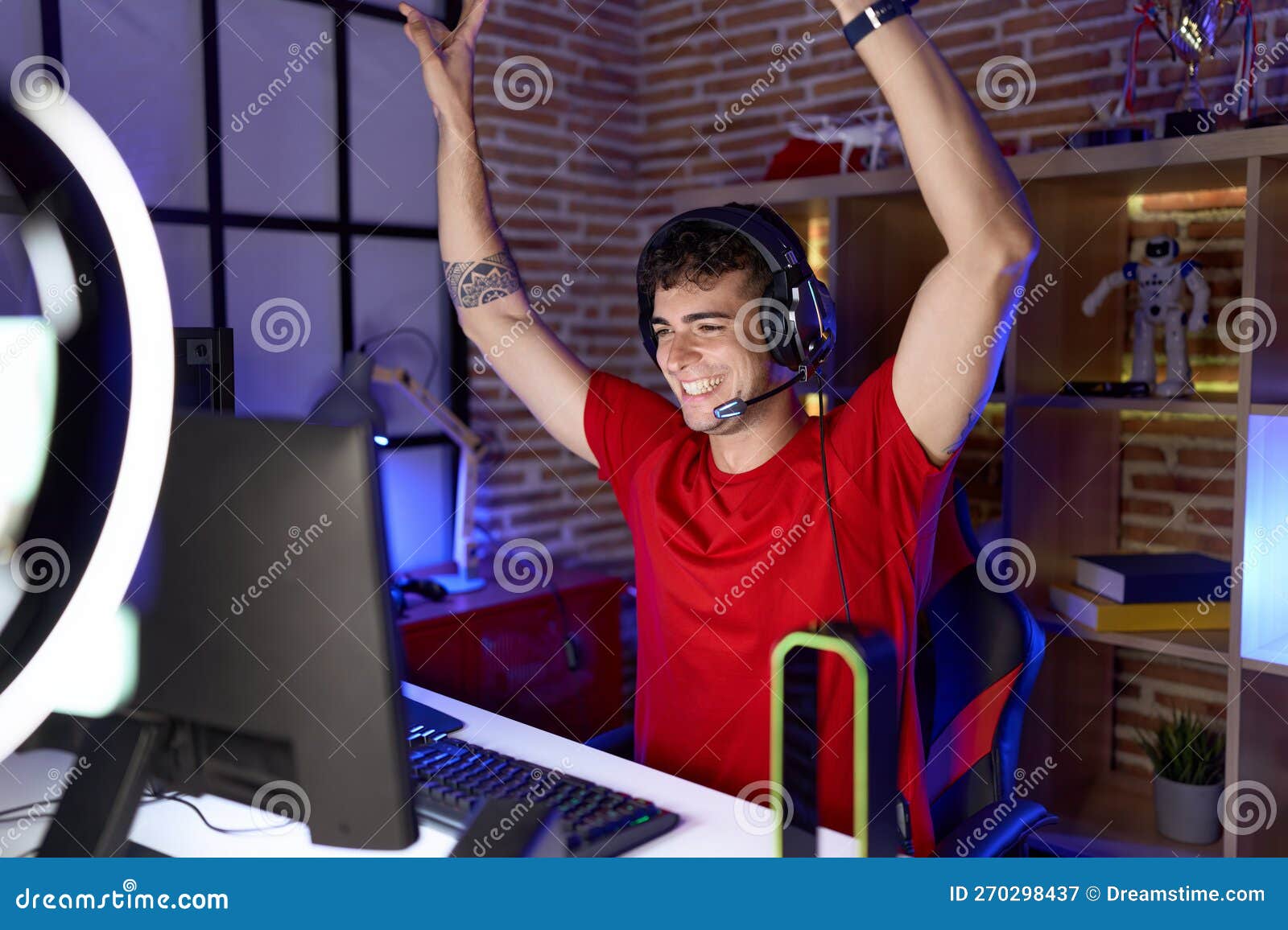 Young Hispanic Man Streamer Playing Video Game with Winner Expression ...