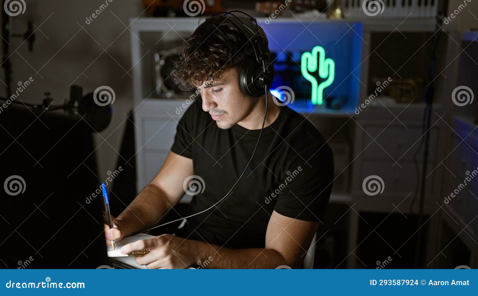 Young Hispanic Man Streamer Sitting on Table Taking Notes at Gaming ...