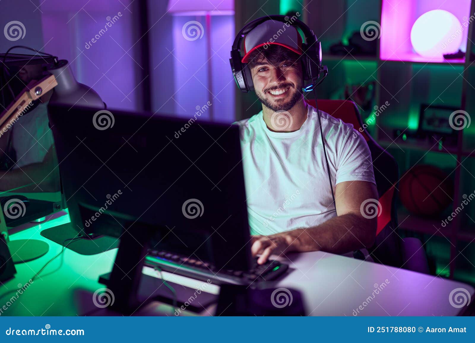 Young Hispanic Man Streamer Using Computer and Headphones at Gamin Room ...