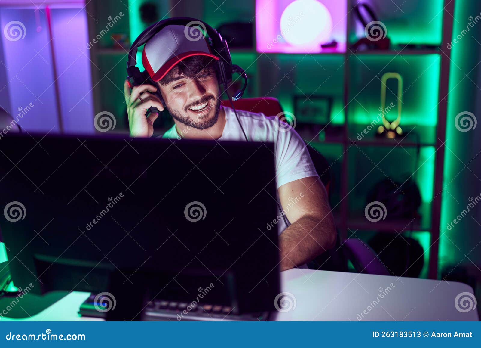Young Hispanic Man Streamer Using Computer and Headphones at Gamin Room ...