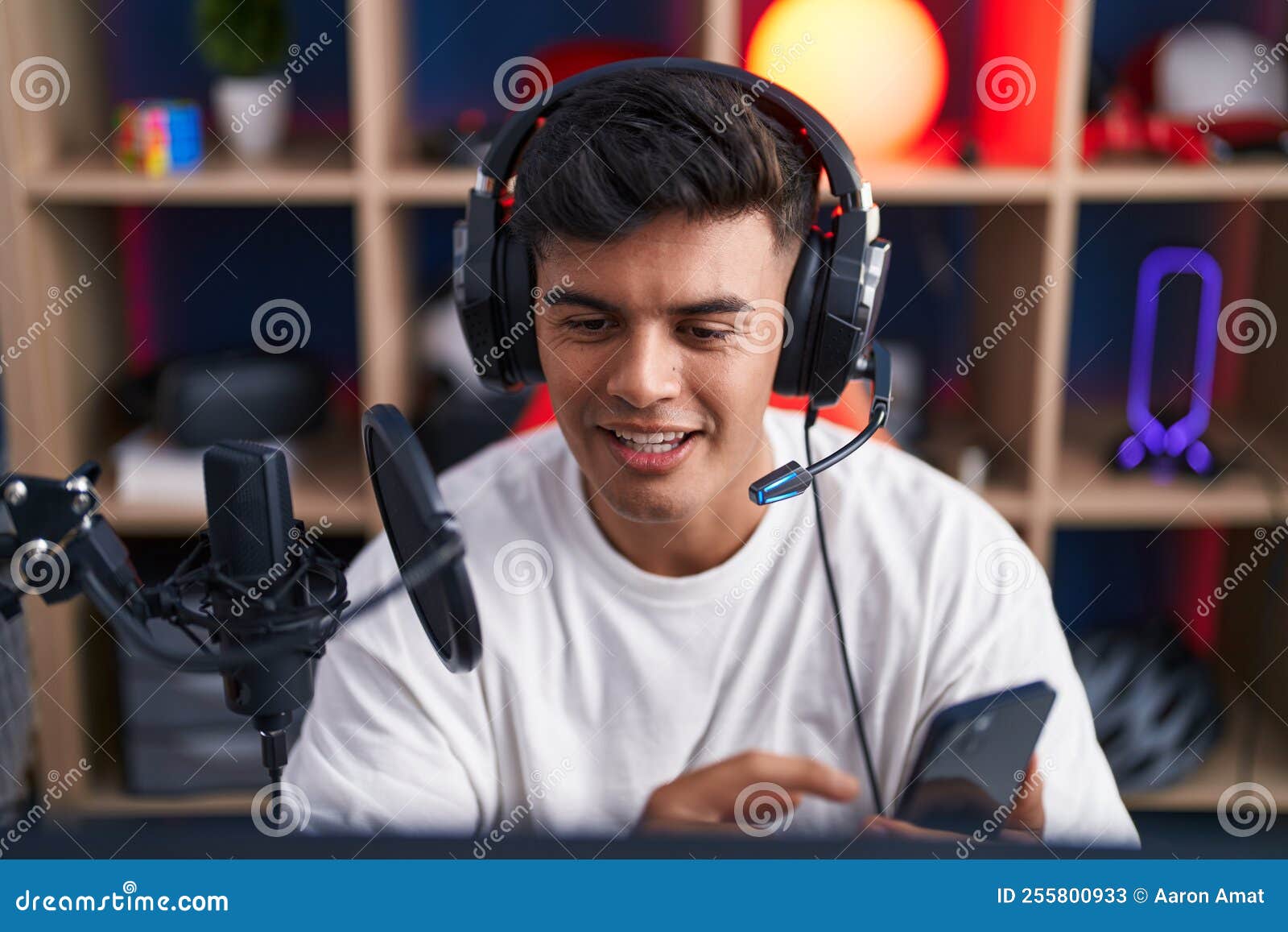 Young Hispanic Man Streamer Using Computer and Smartphone at Gaming ...