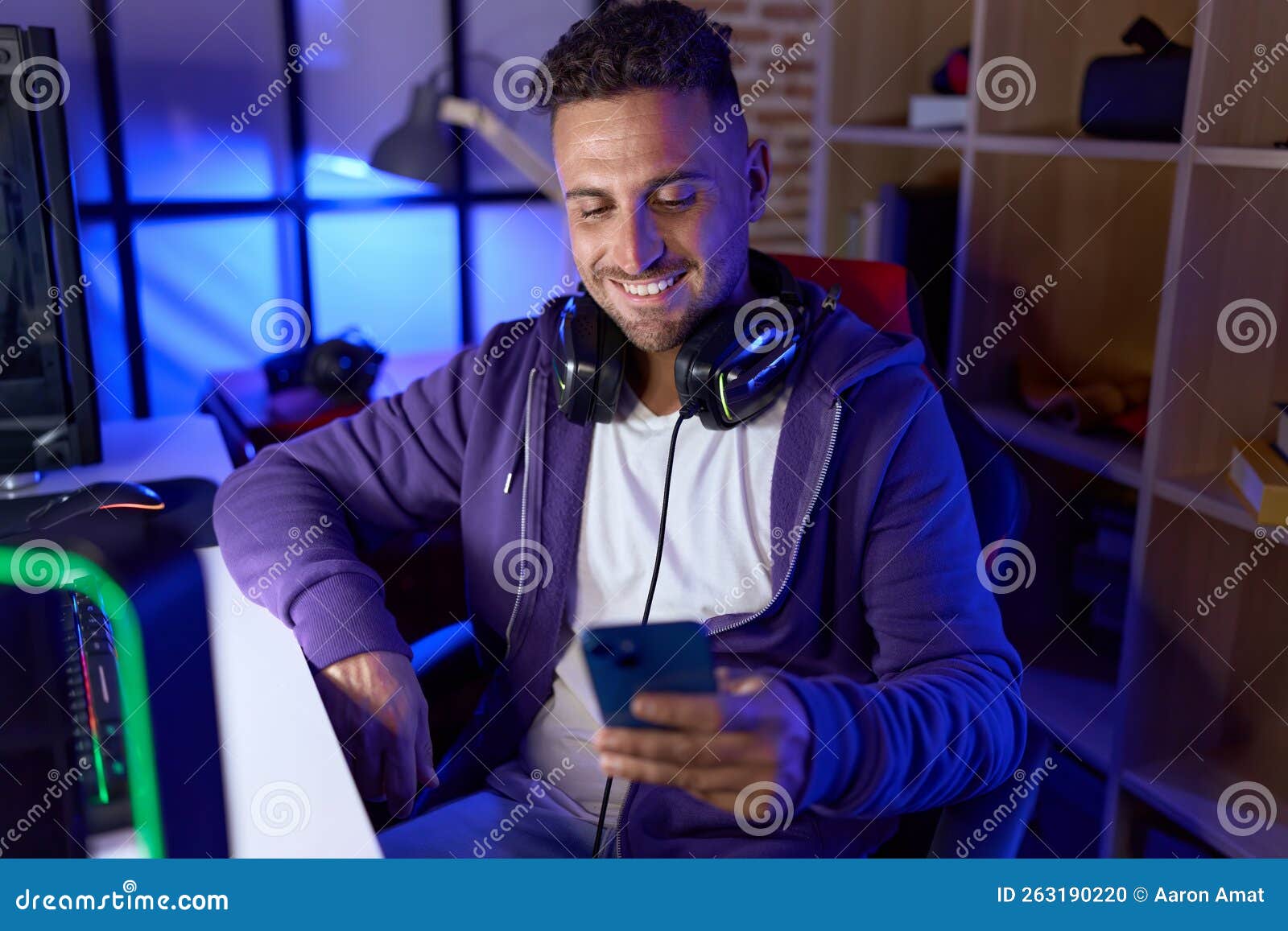 Young Hispanic Man Streamer Using Computer and Smartphone at Gaming ...