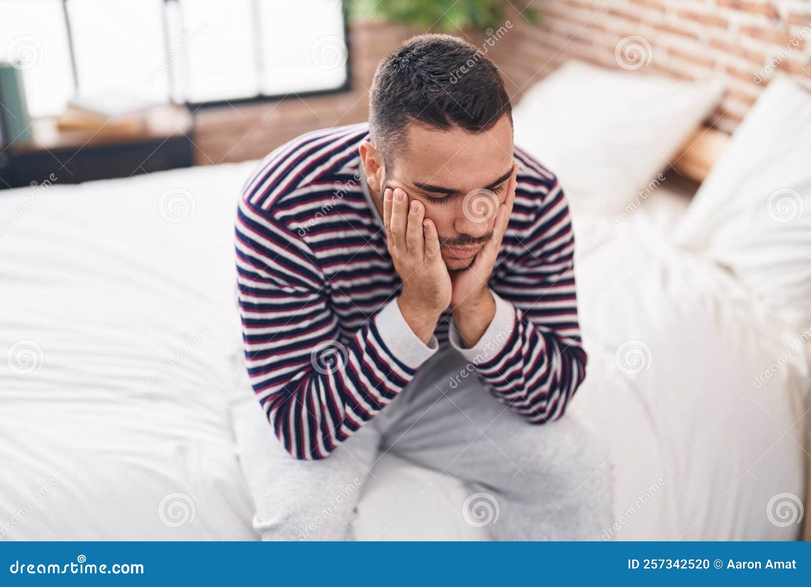 Young Hispanic Man Stressed Sitting on Bed at Bedroom Stock Photo ...
