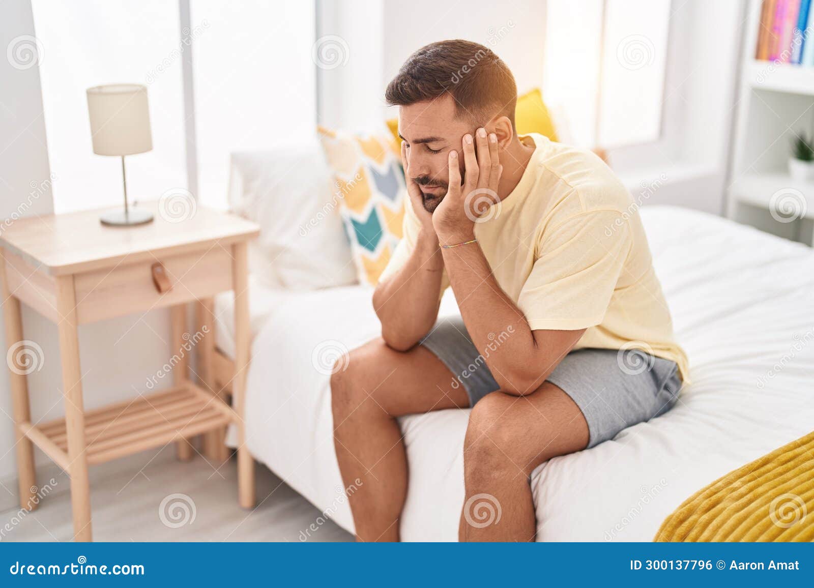 Young Hispanic Man Stressed Sitting on Bed at Bedroom Stock Photo ...