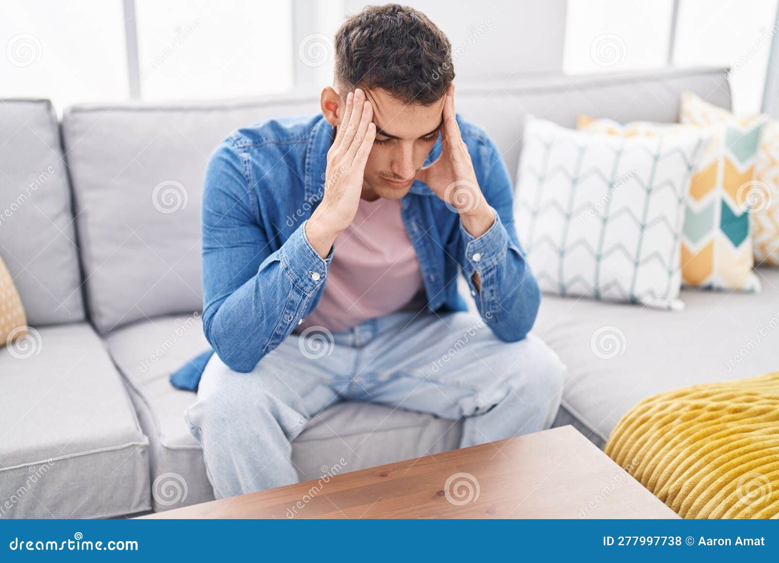 Young Hispanic Man Stressed Sitting on Sofa at Home Stock Photo - Image ...