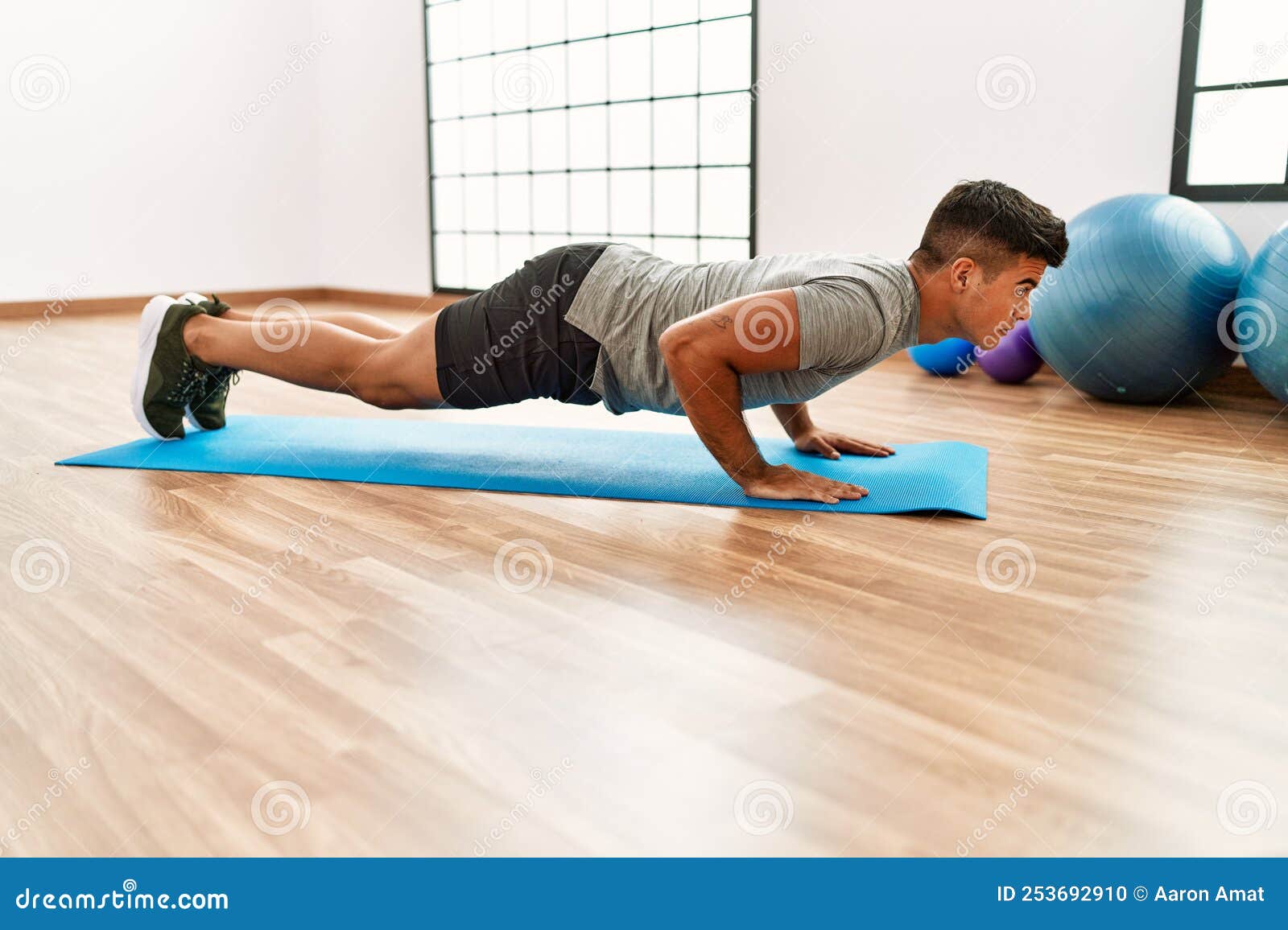 Young Hispanic Man Training Abs Exercise at Sport Center Stock Photo ...