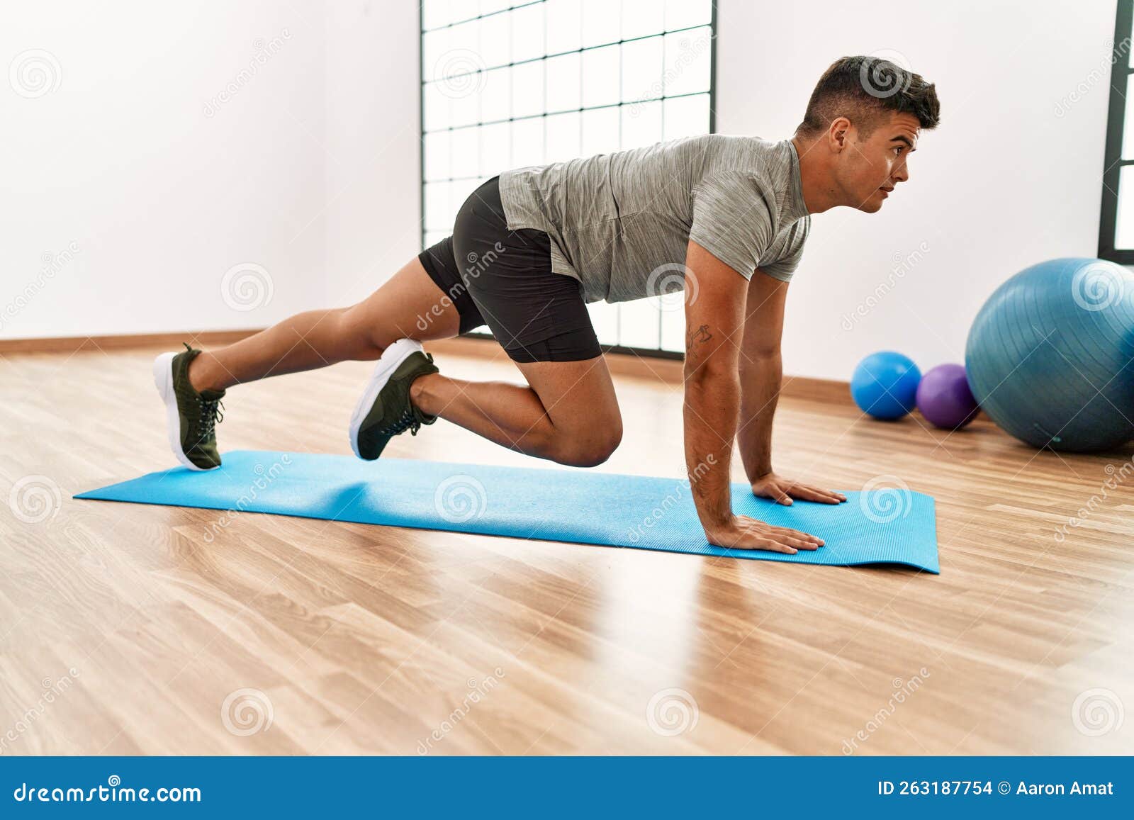 Young Hispanic Man Training Abs Exercise at Sport Center Stock Photo ...