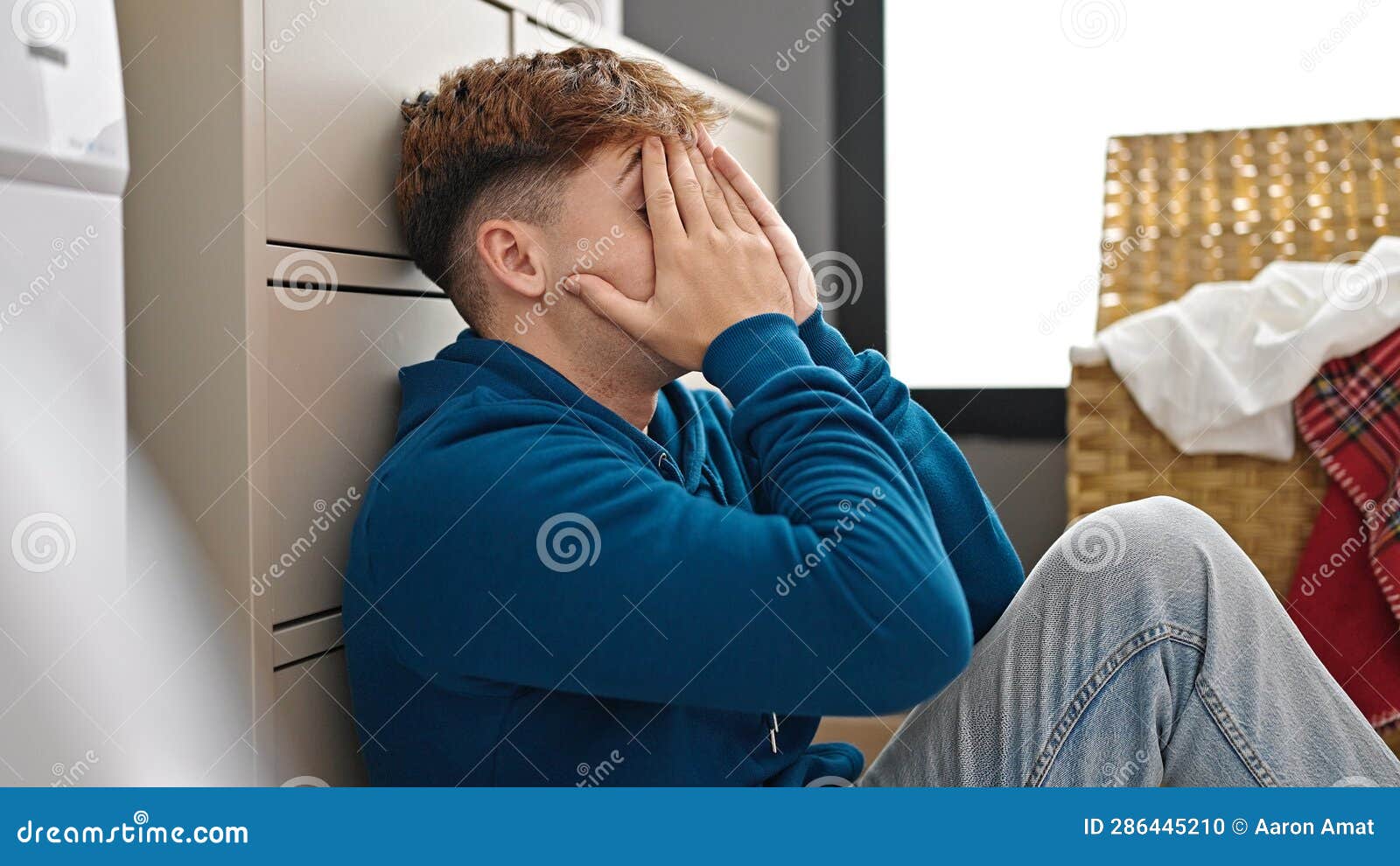 Young Hispanic Man Washing Clothes Stressed at Laundry Room Stock Photo ...