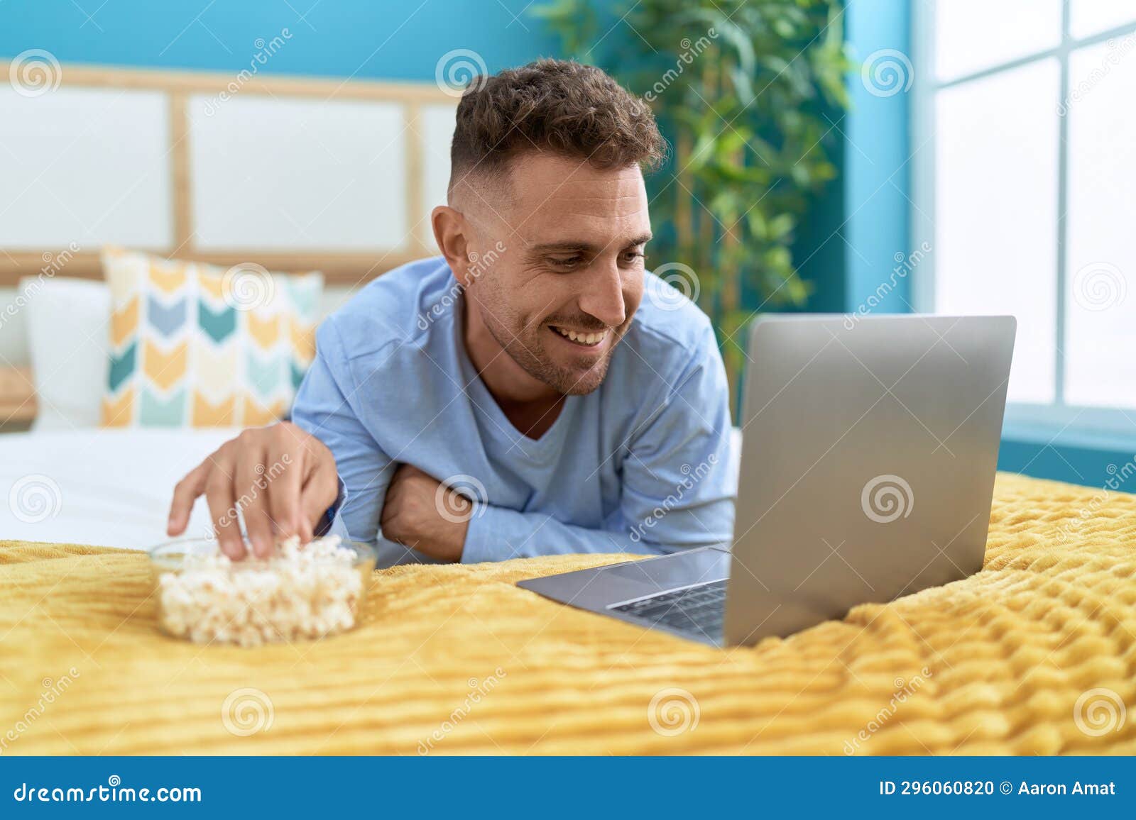 Young Hispanic Man Watching on Laptop Lying on Bed at Bedroom Stock ...