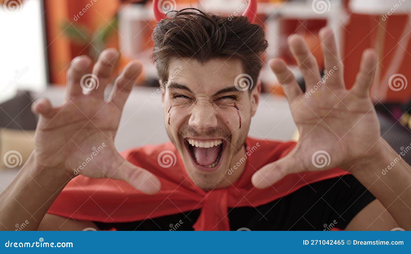 Young Hispanic Man Wearing Devil Costume Doing Scare Gesture at Home ...