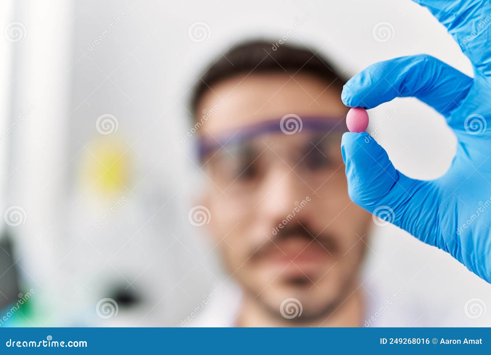 Young Hispanic Man Wearing Scientist Uniform Holding Pill at Laboratory ...