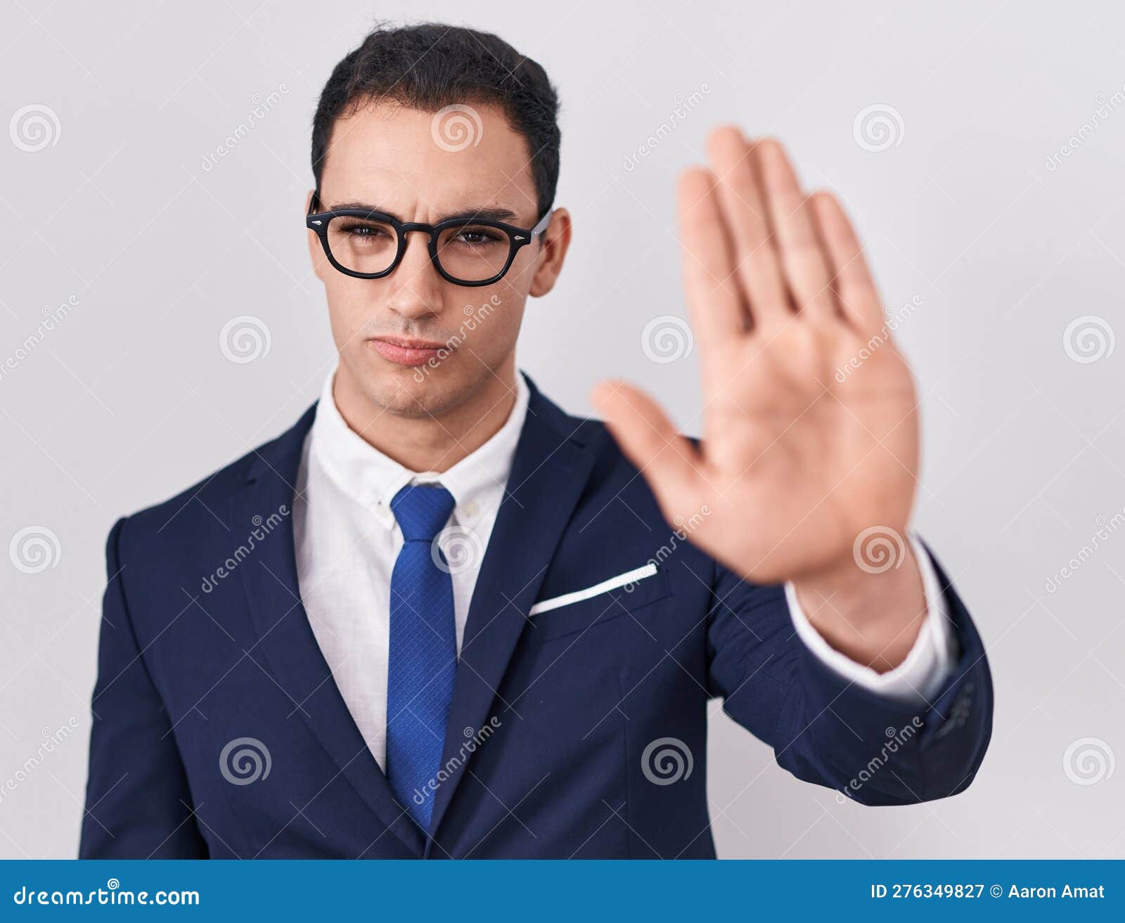 Young Hispanic Man Wearing Suit and Tie Doing Stop Sing with Palm of ...