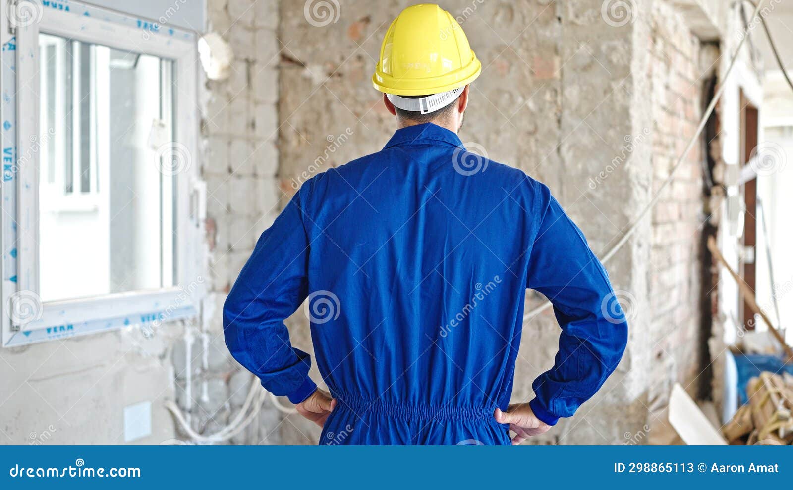 Young Hispanic Man Worker Wearing Hardhat Standing Backwards at ...