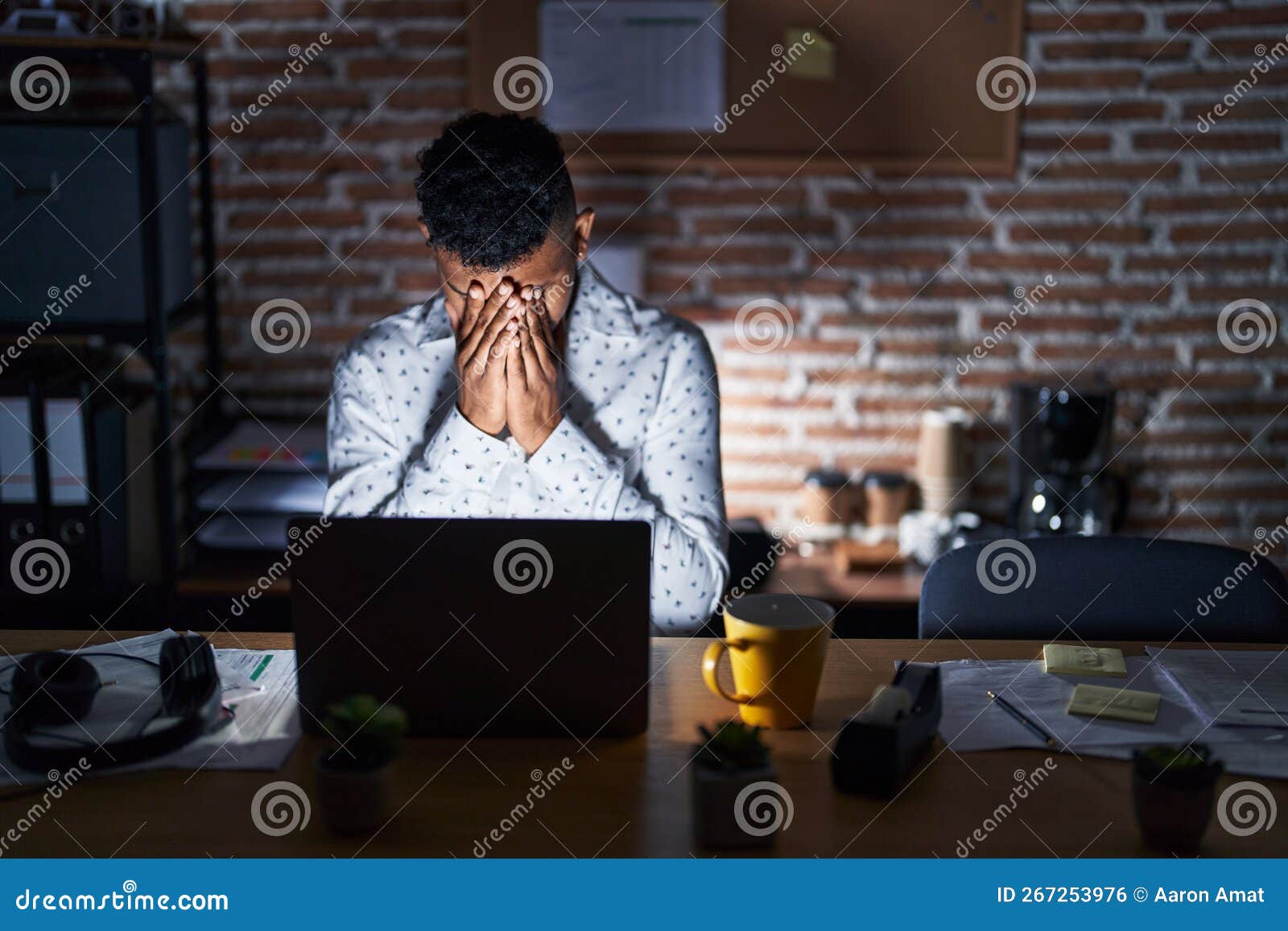 Young Hispanic Man Working at the Office at Night with Sad Expression ...
