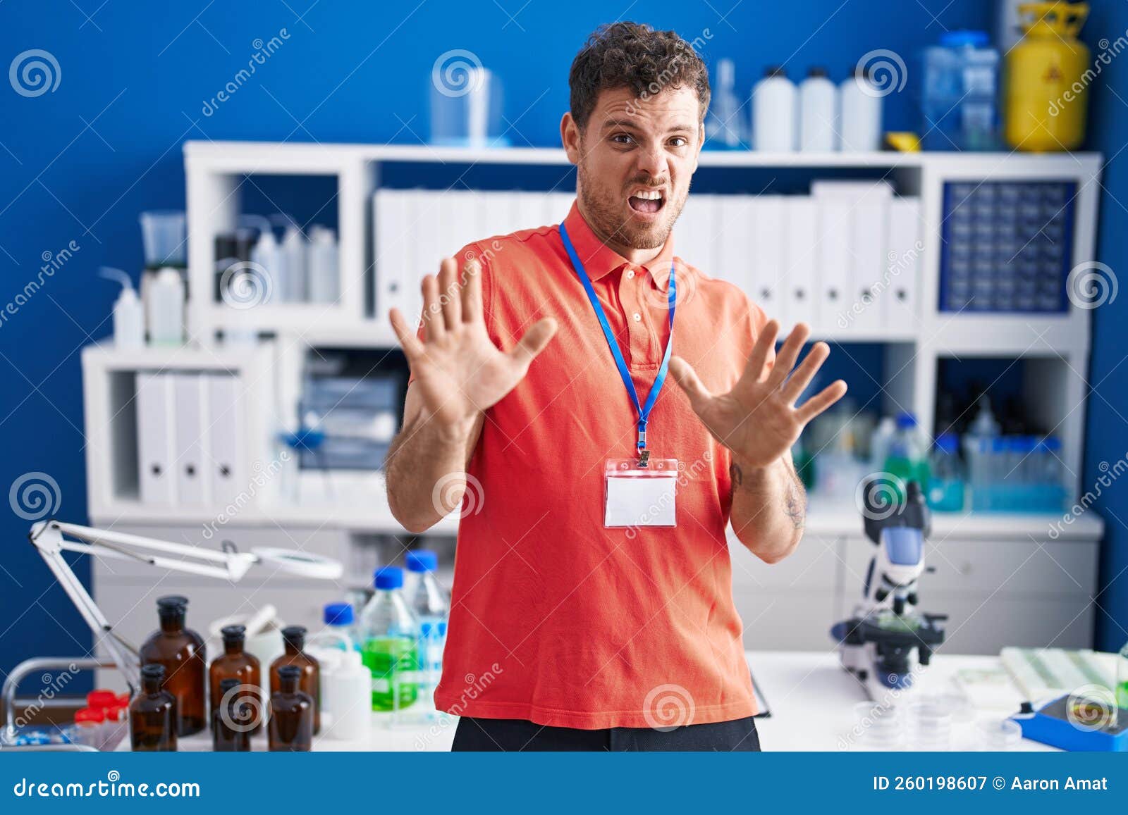 Young Hispanic Man Working at Scientist Laboratory Afraid and Terrified ...