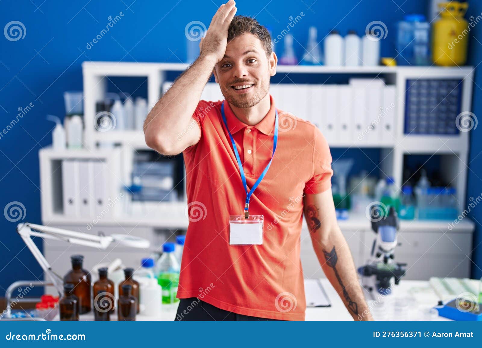 Young Hispanic Man Working at Scientist Laboratory Surprised with Hand ...