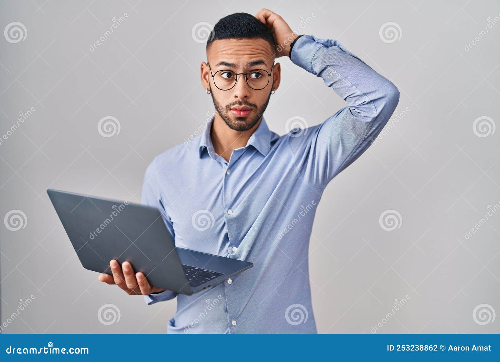Young Hispanic Man Working Using Computer Laptop Confuse and Wondering ...