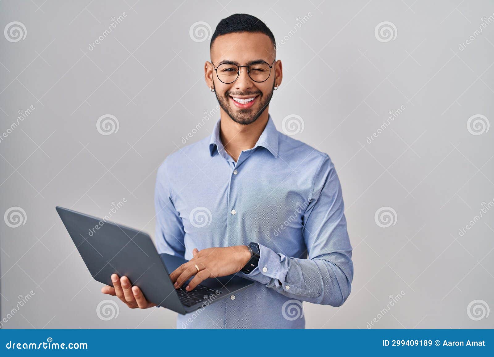 Young Hispanic Man Working Using Computer Laptop Winking Looking at the ...