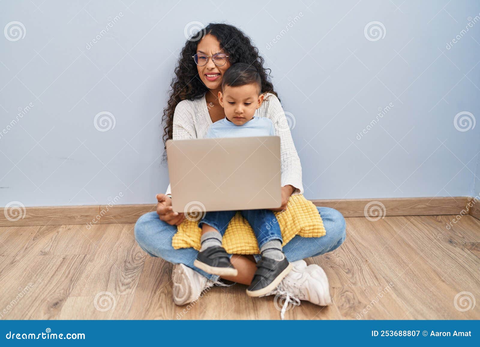 Young Hispanic Mother and Kid Using Computer Laptop Sitting on the ...
