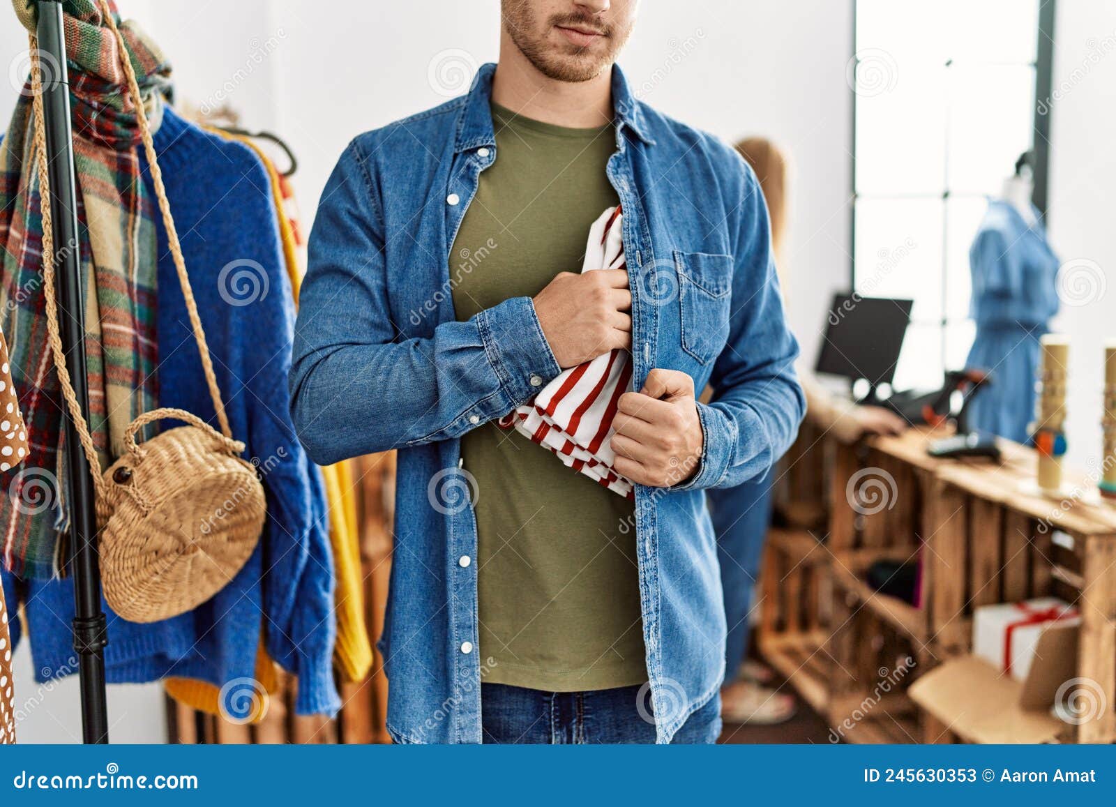 Young Hispanic Robber Man Stealing Shirt at Clothes Store Stock Image ...