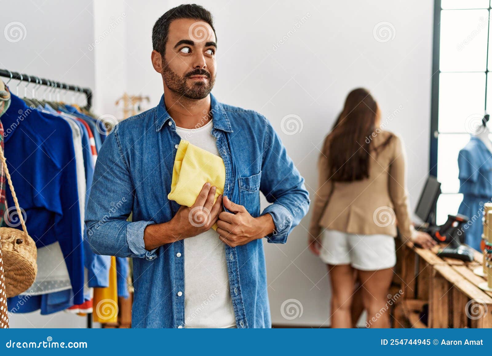 Young Hispanic Robber Man Stealing Shirt at Clothes Store Stock Image ...