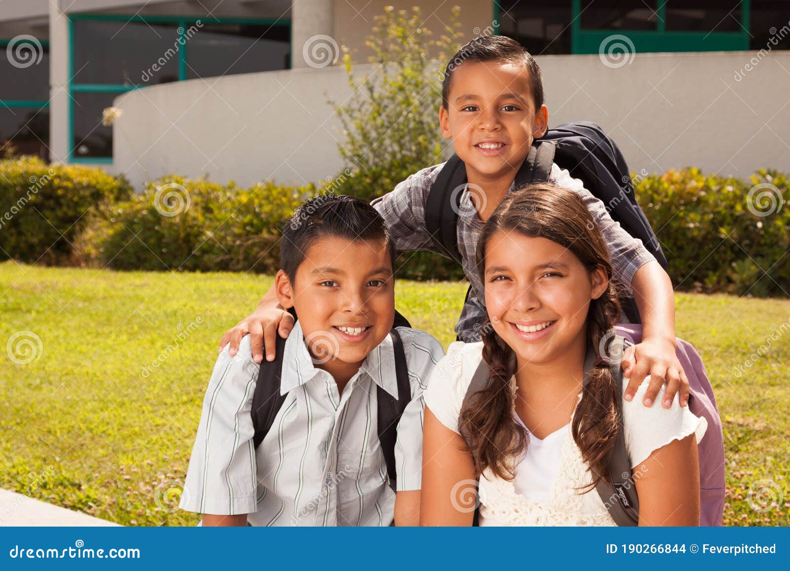 Young Hispanic Student Children Wearing Backpacks on School Campus ...