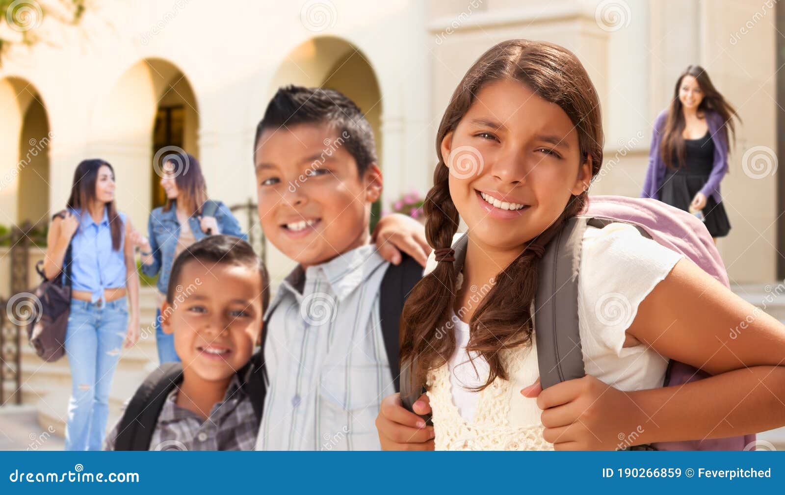 Young Hispanic Student Children Wearing Backpacks on School Campus ...