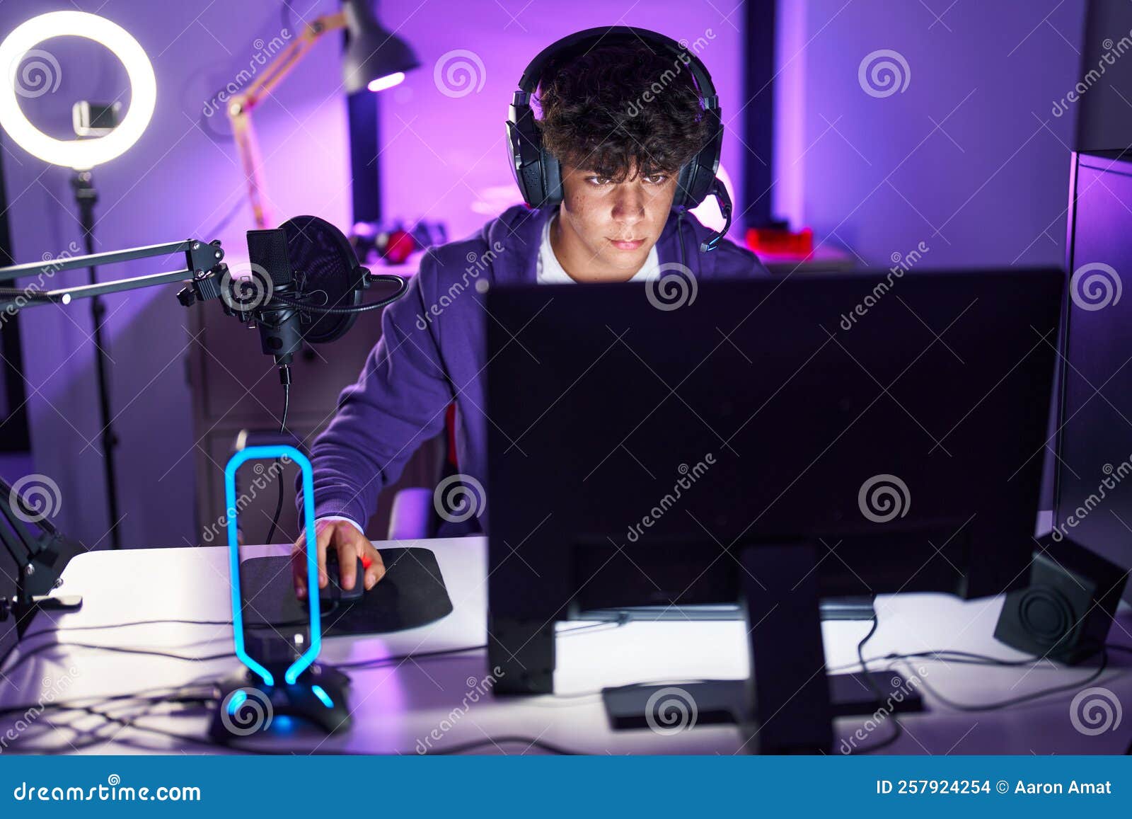 Young Hispanic Teenager Streamer Playing Video Game Using Computer at ...