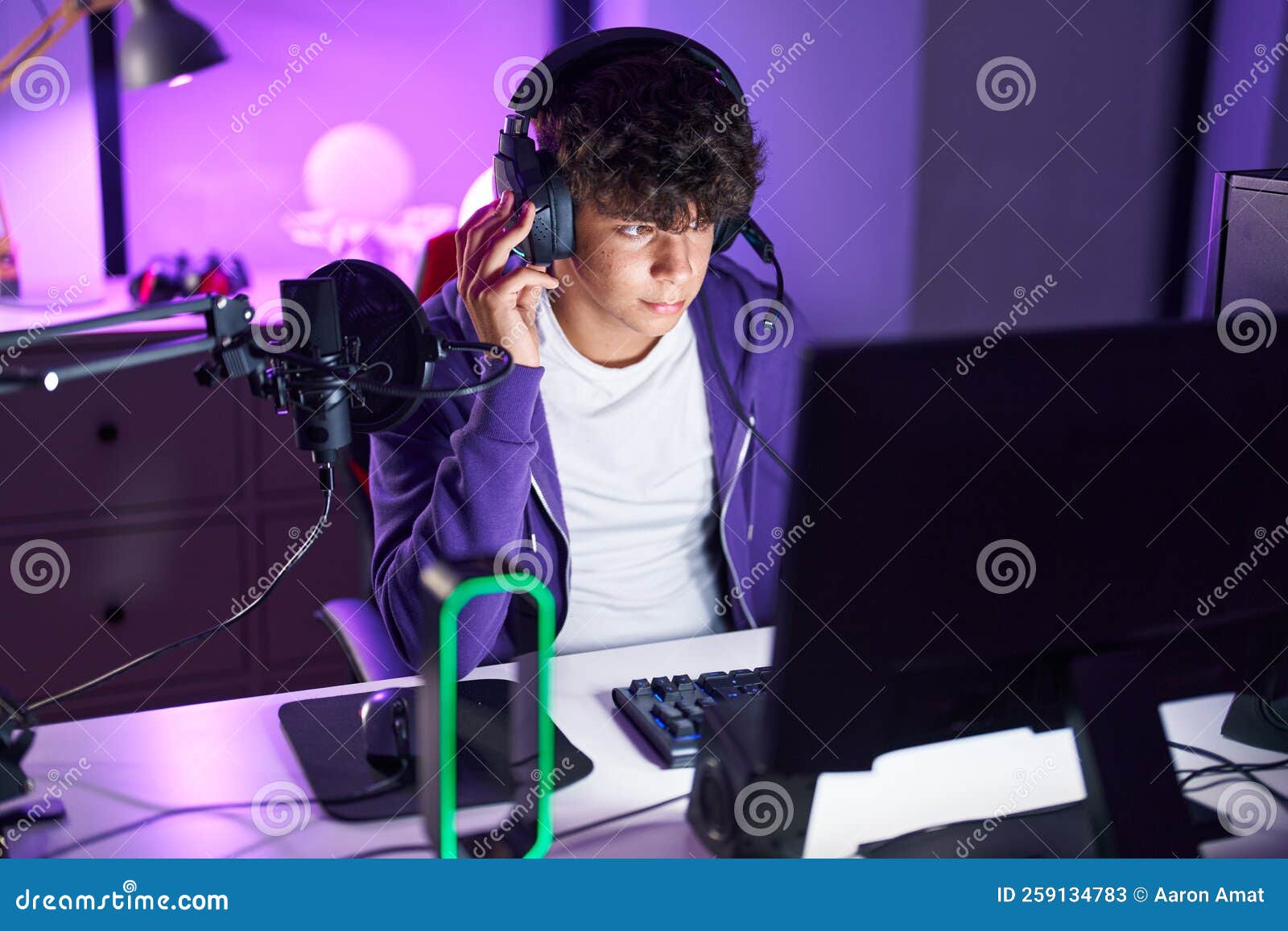 Young Hispanic Teenager Streamer Playing Video Game Using Computer at ...