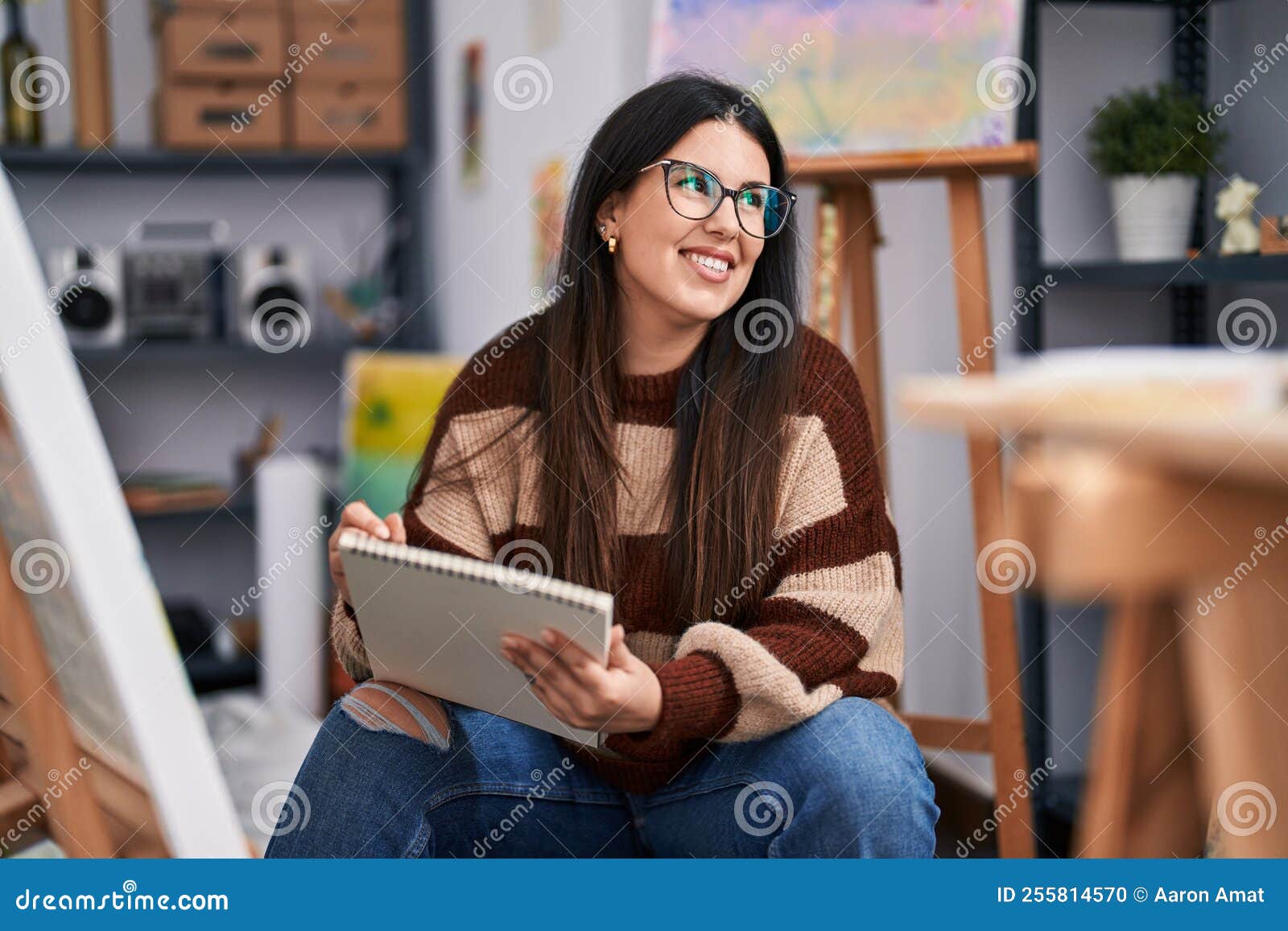 Young Hispanic Woman Artist Drawing on Notebook at Art Studio Stock ...
