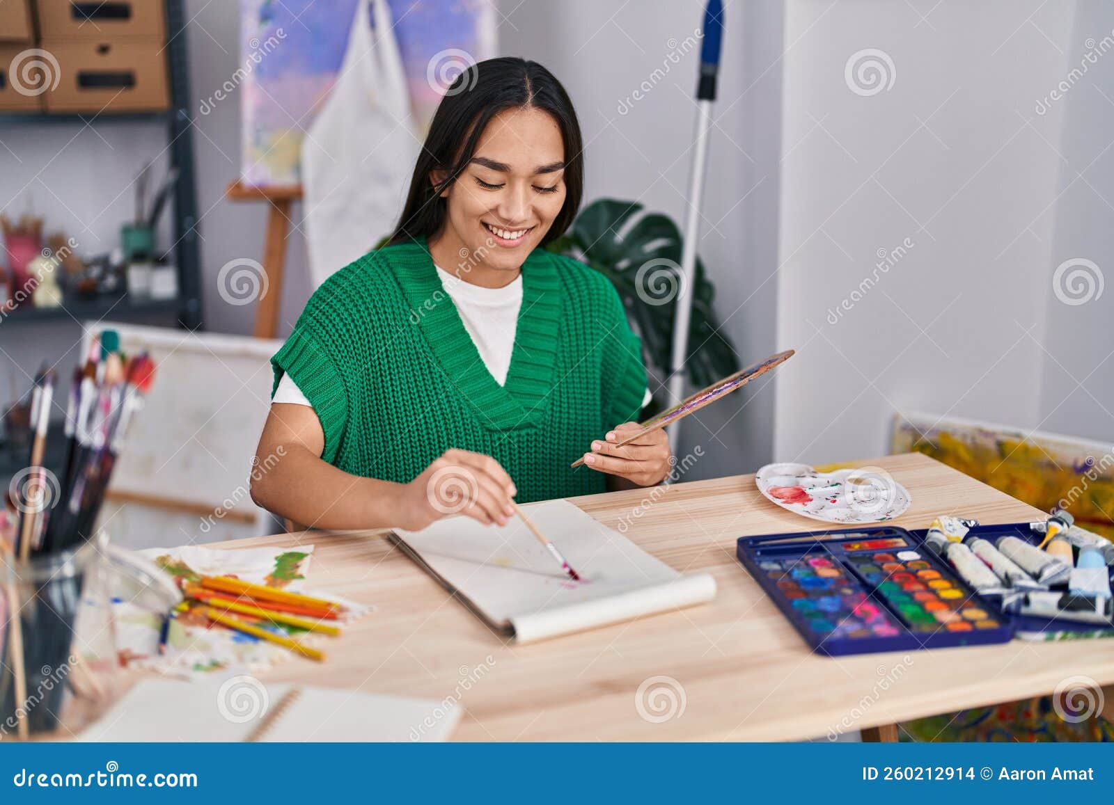 Young Hispanic Woman Artist Drawing on Notebook at Art Studio Stock ...
