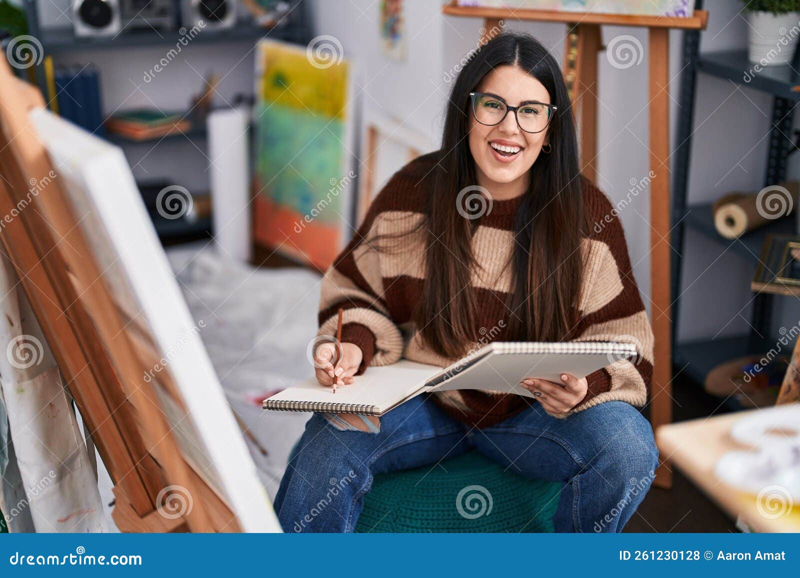 Young Hispanic Woman Artist Drawing on Notebook at Art Studio Stock ...