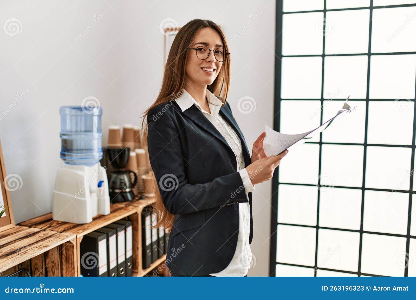 Young Hispanic Woman Business Worker Reading Paperwork Working at ...