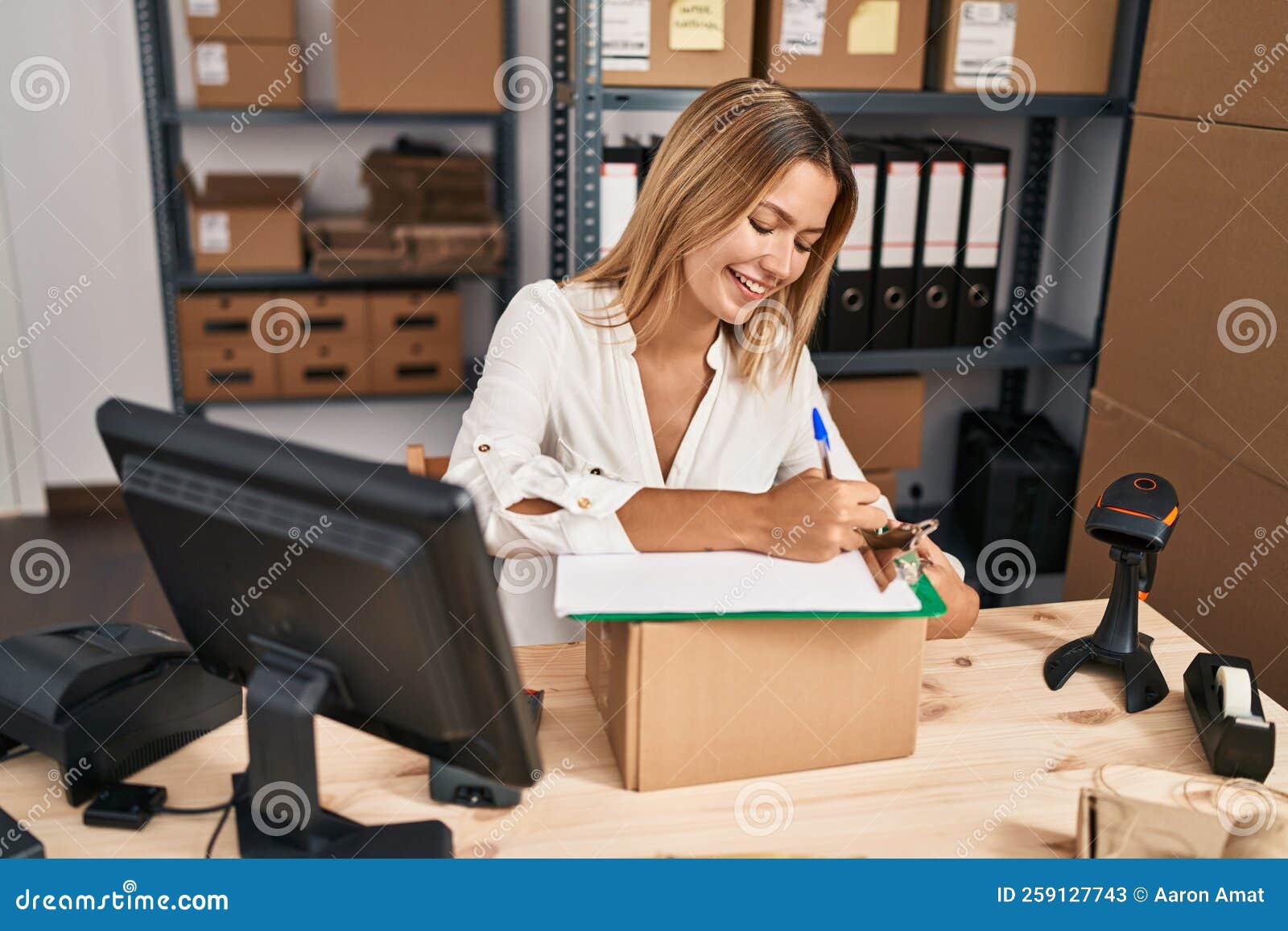 Young Hispanic Woman Ecommerce Business Worker Writing on Document at ...