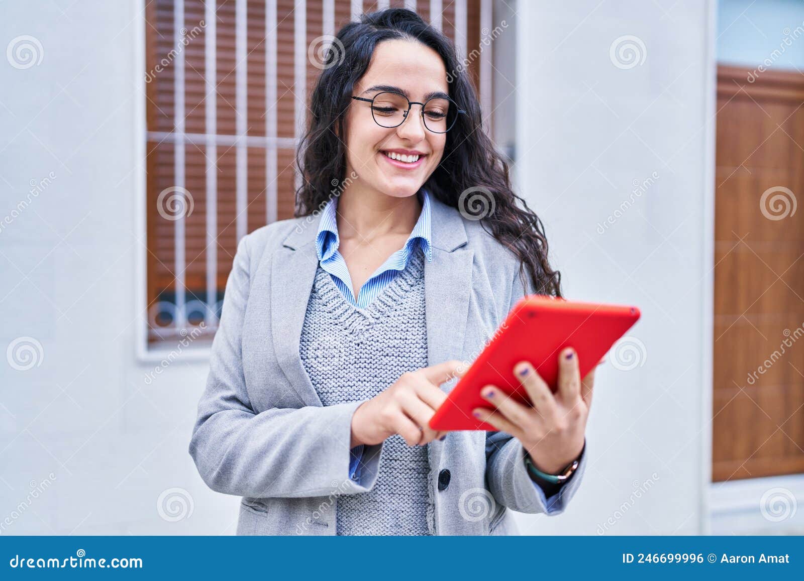Young Hispanic Woman Executive Using Touchpad Standing at Street Stock ...