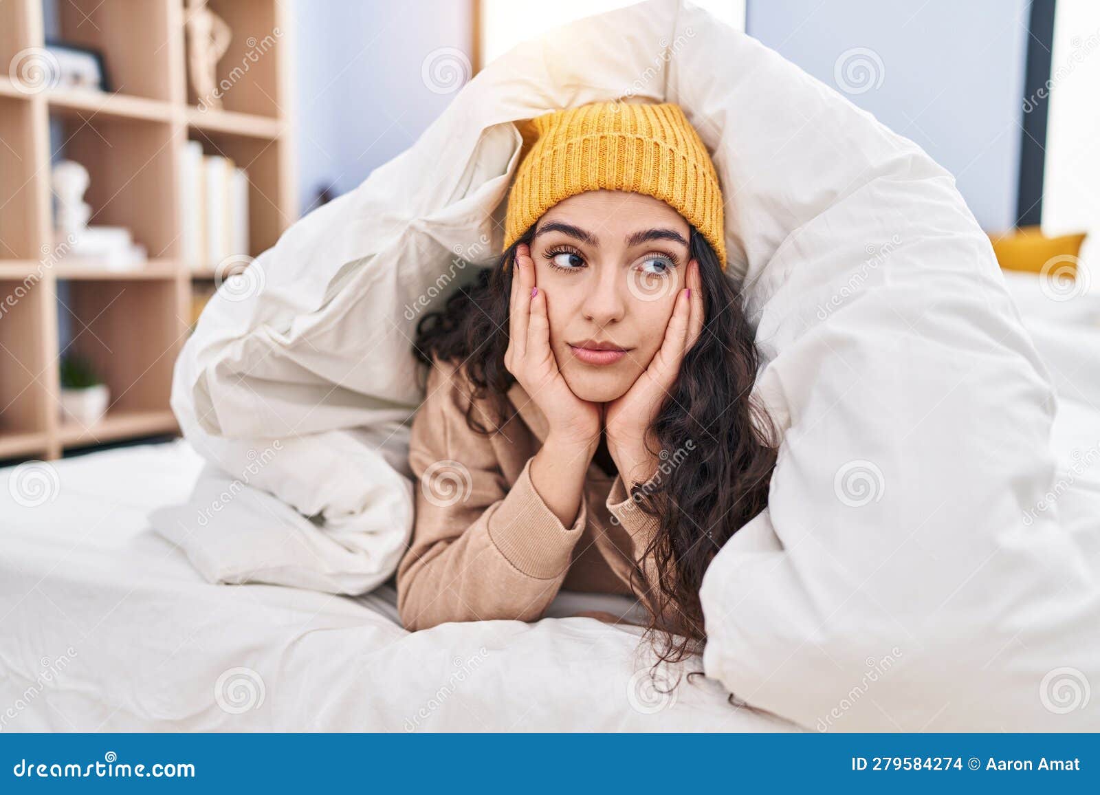 Young Hispanic Woman Lying on Bed with Relaxed Expression at Bedroom ...