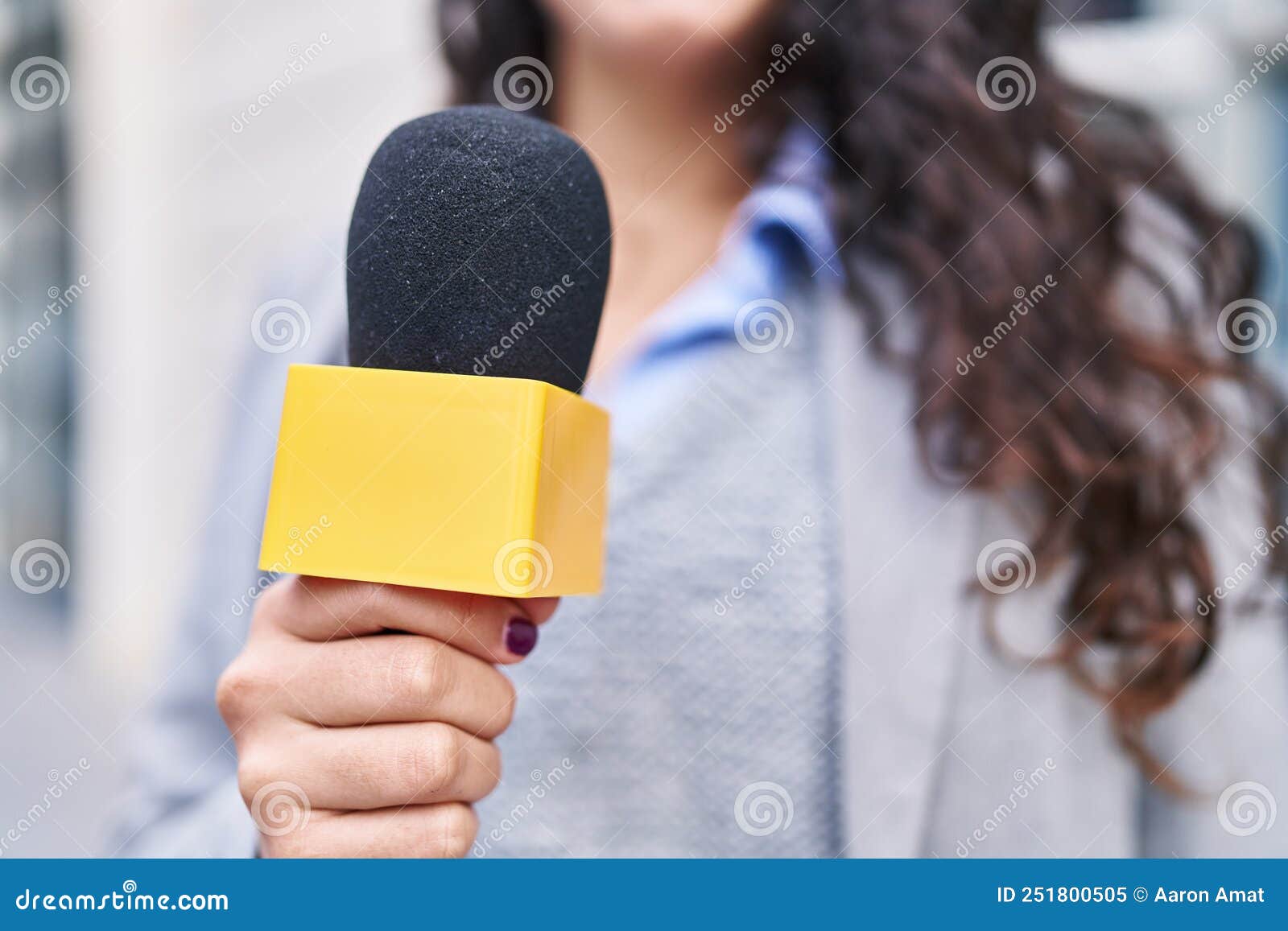 Young Hispanic Woman Reporter Working Using Microphone at Street Stock ...